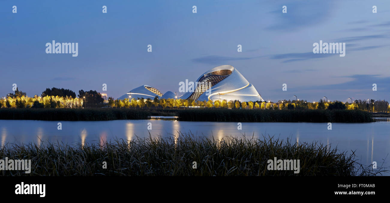 Distant view towards opera from river at night. Harbin Opera House ...