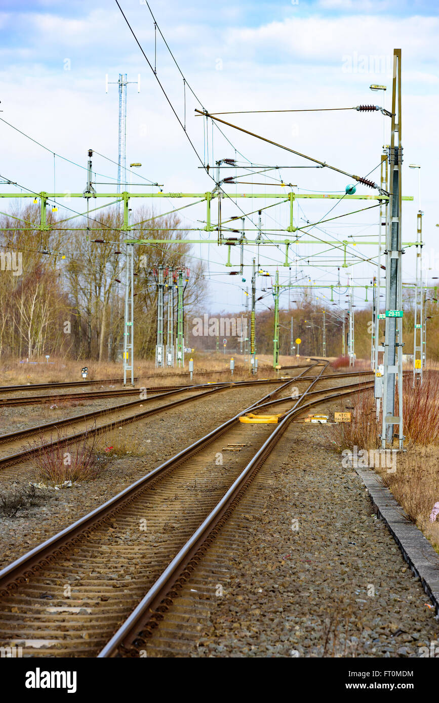 Empty railroad track with som train switches and electrical wires ...