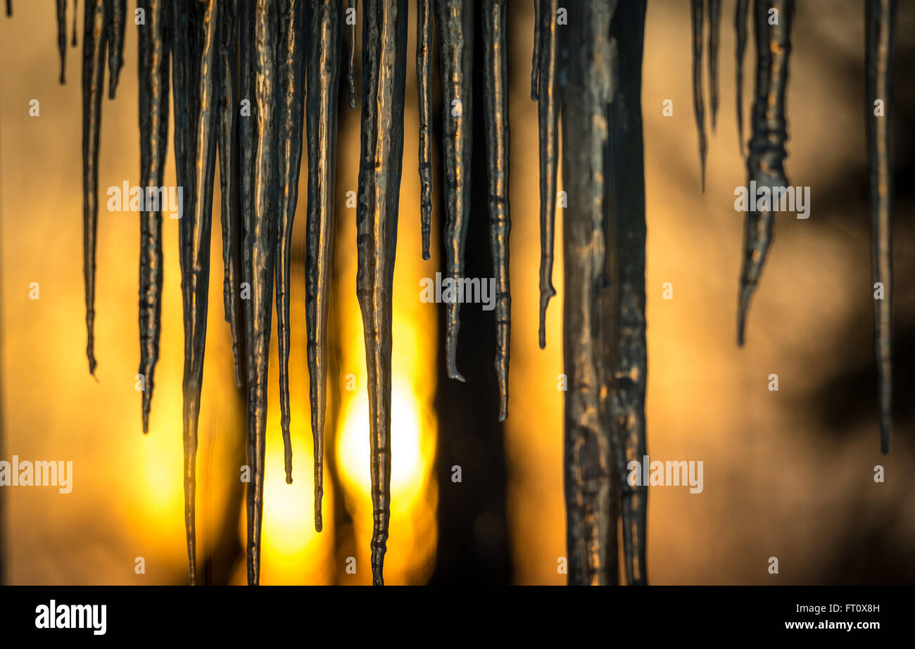 Abstract background of sunrise through natural icicle formation as it ...