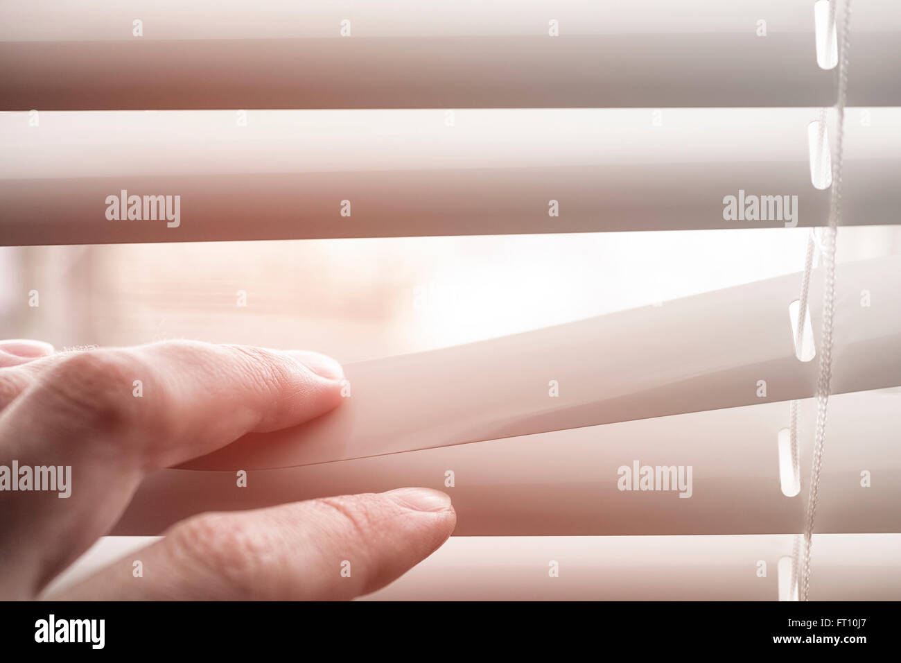 Person looking through the window shutters Stock Photo - Alamy
