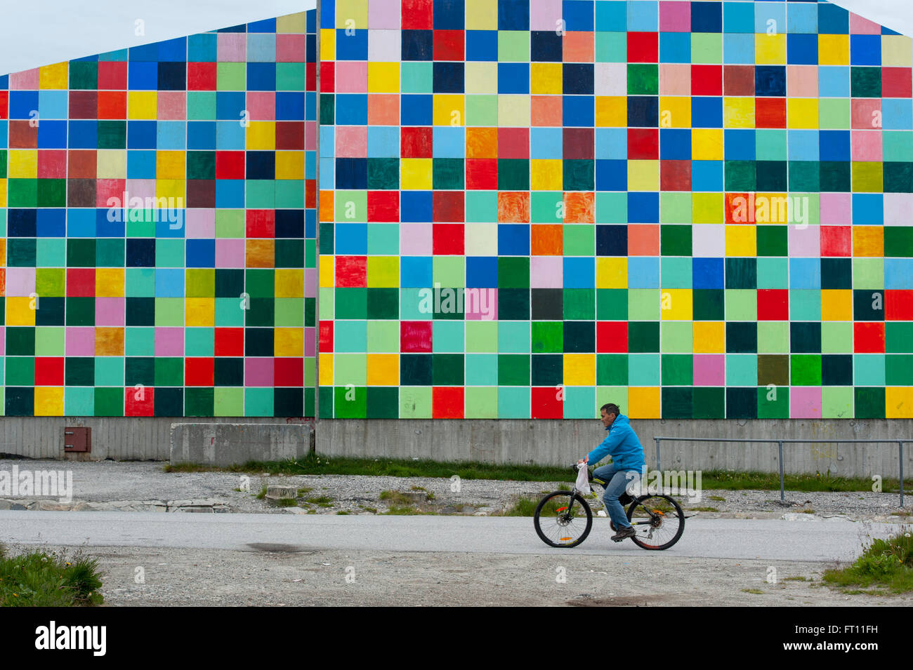 Cyclist passing a building with colorful squares, Nuuk, Greenland Stock ...