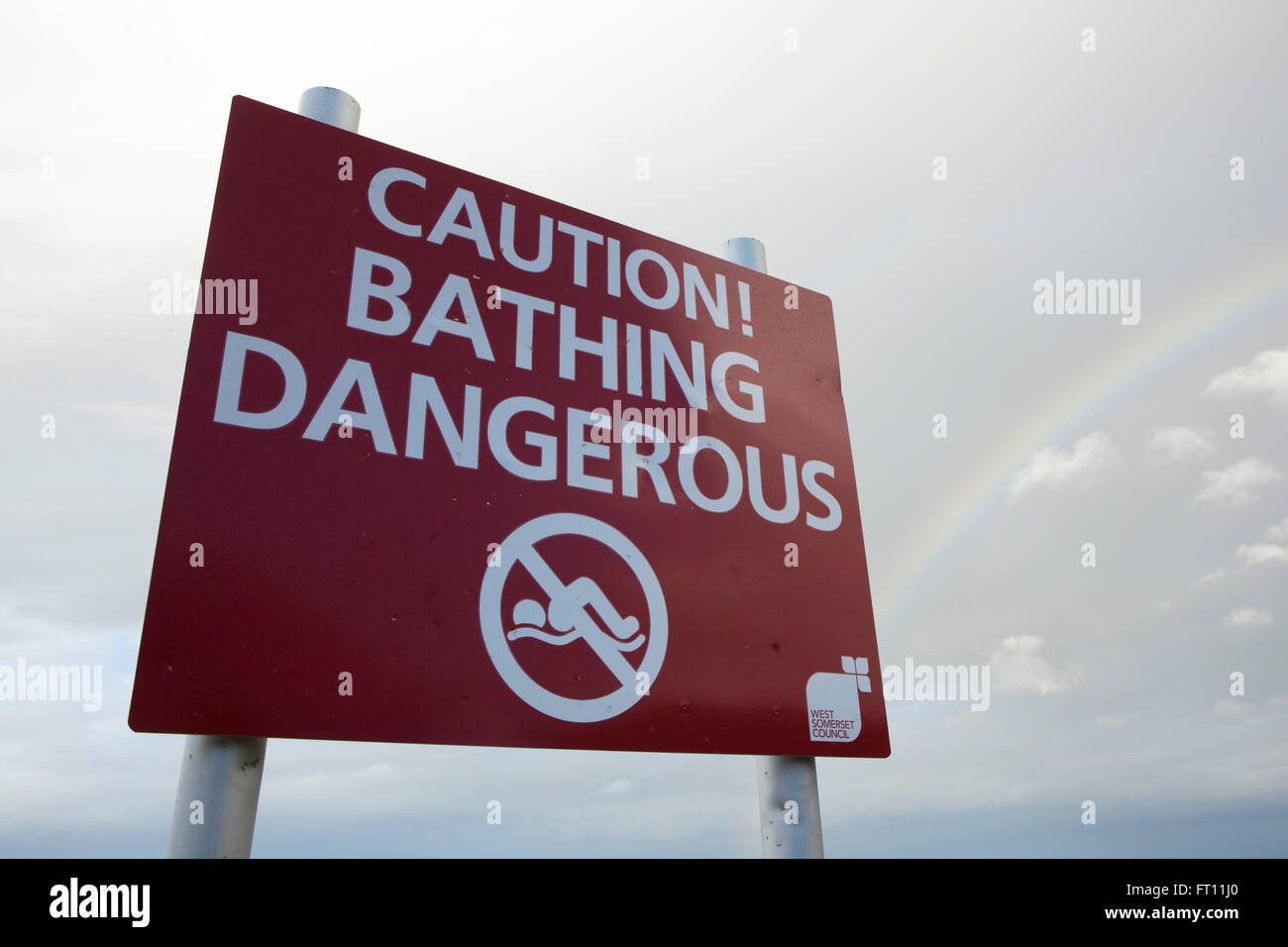 A large sign at the entrance to a beach warning of the danger of ...