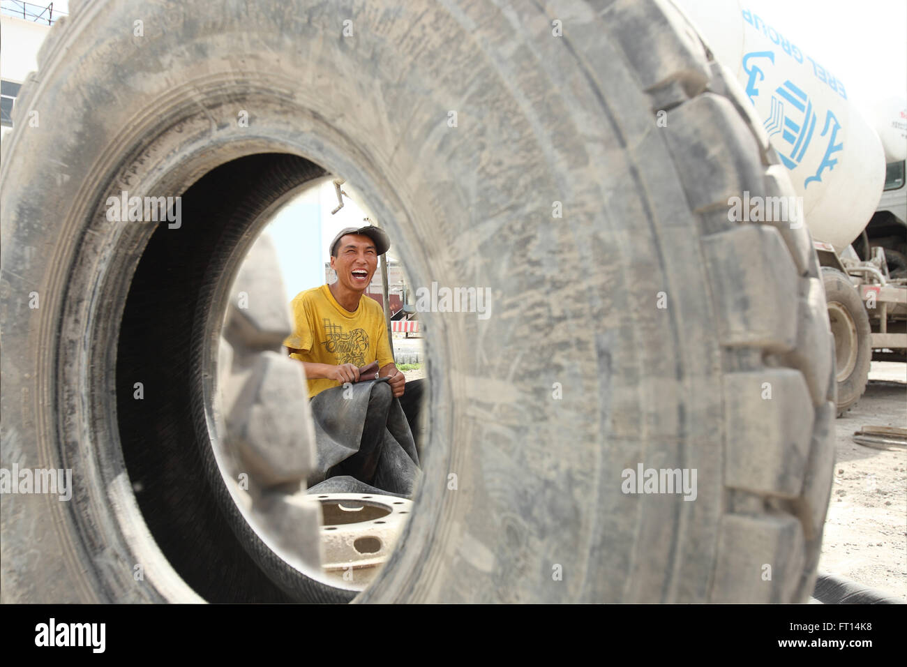Worker behind a tire, tire repair shop, Ulaanbaatar, Mongolia Stock ...
