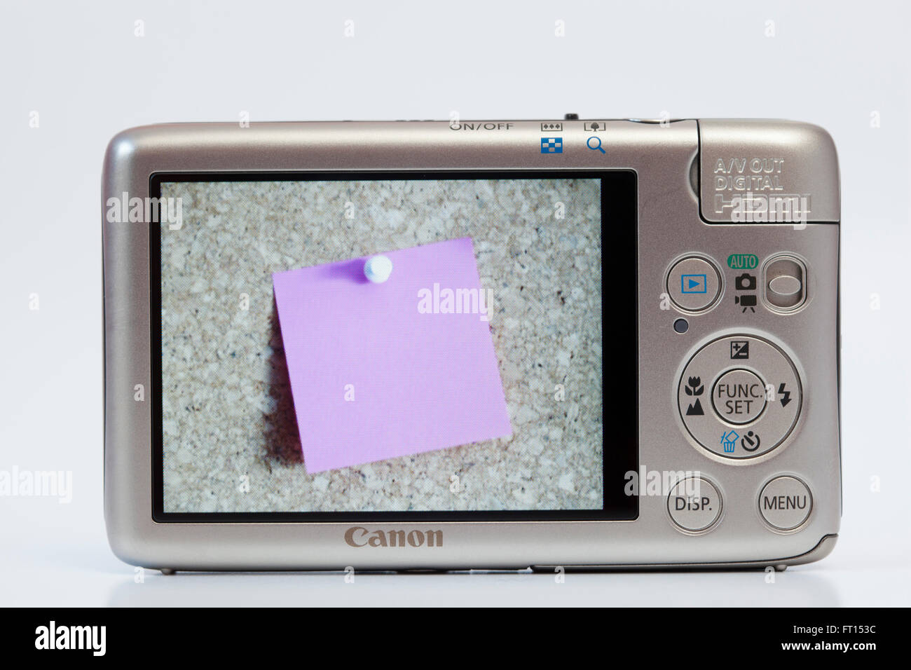 The back of a digital camera with a picture of a pink post it note on a ...