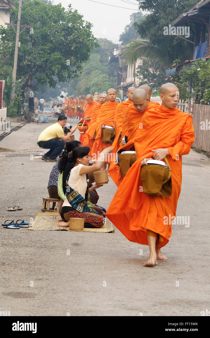 Buddhist monks receiving alms Stock Photo - Alamy