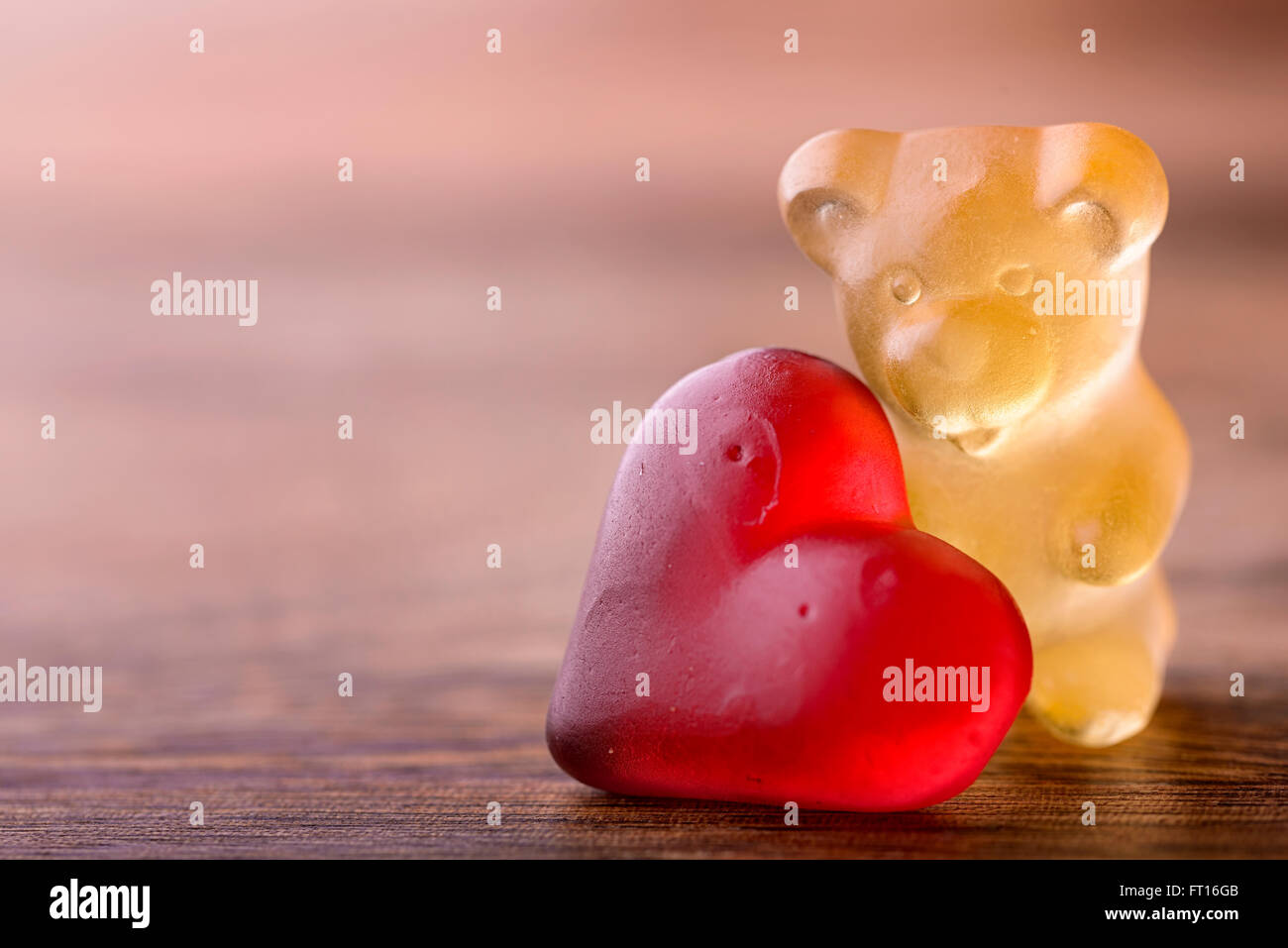 gummy bear with red heart on wood for valentines Stock Photo - Alamy