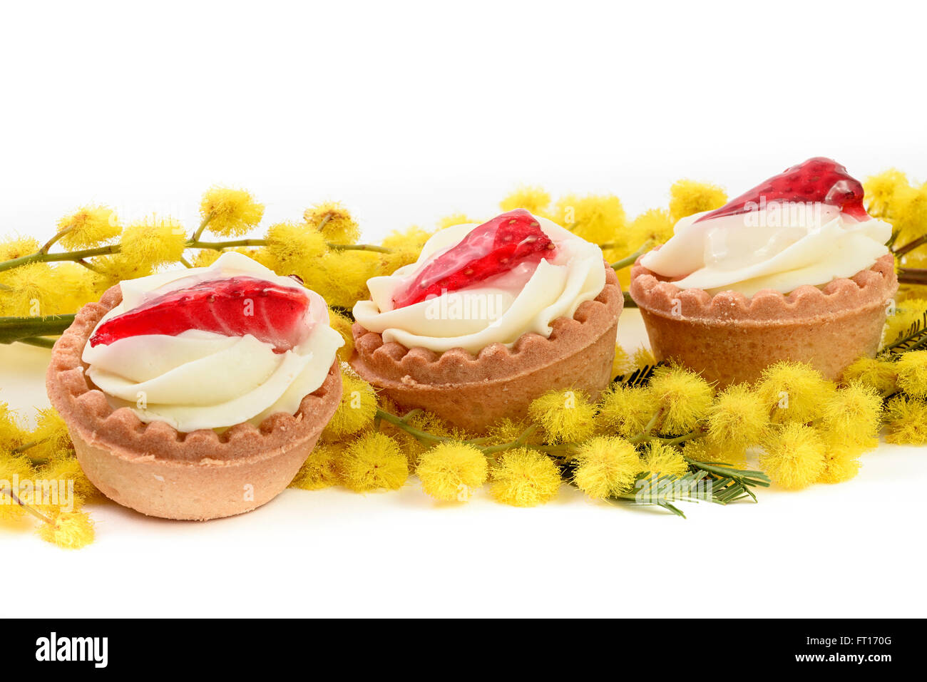 three strawberry pastry and mimosa on white background Stock Photo - Alamy