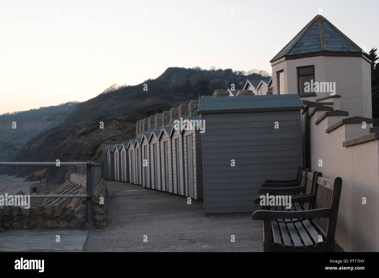 gray wooden huts facing the sun, benches Stock Photo - Alamy