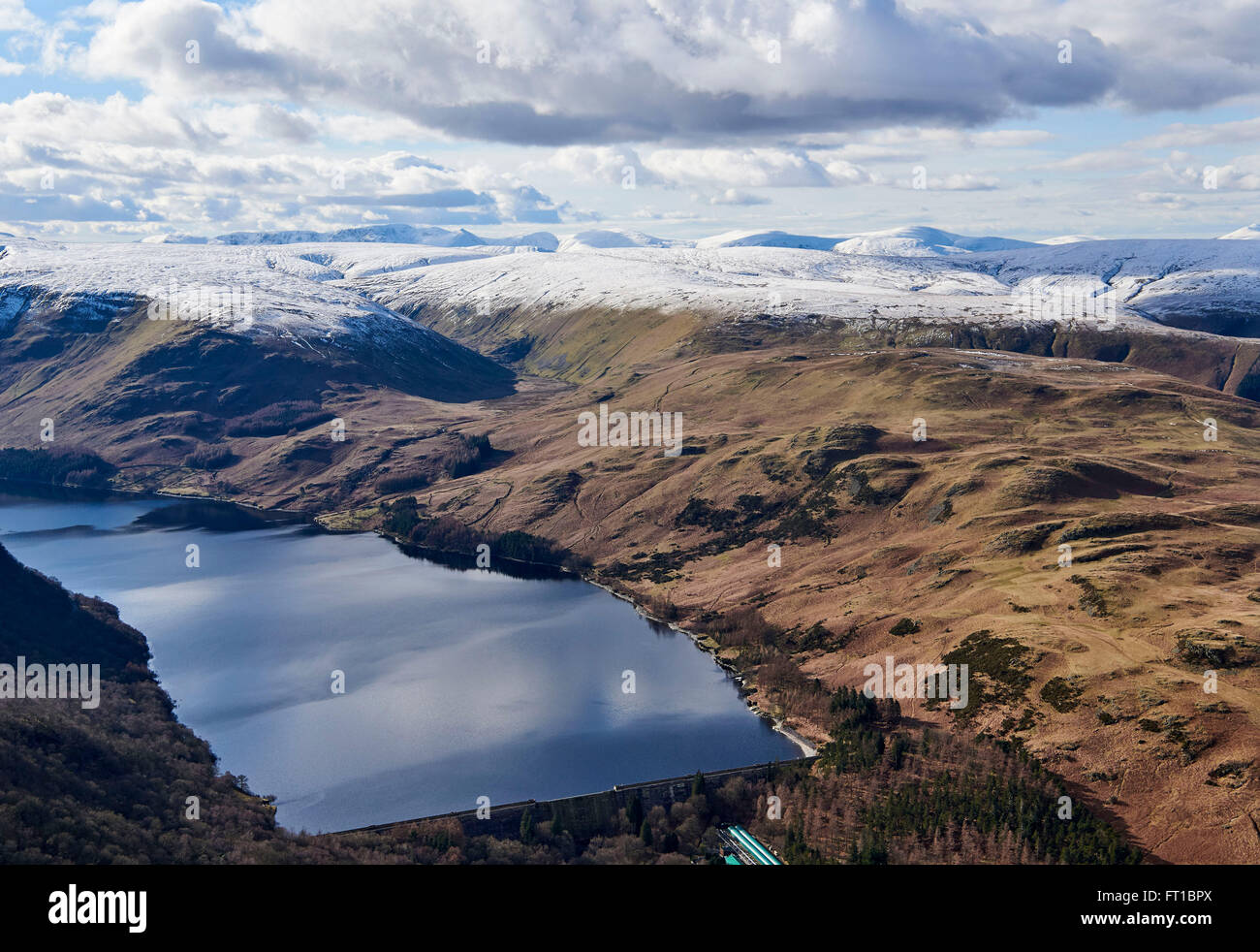 An aerial view of Haweswater Reservoir and the Lake District with snow ...