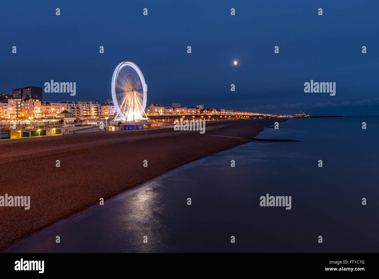 Brighton wheel and the moon at seaside Stock Photo - Alamy