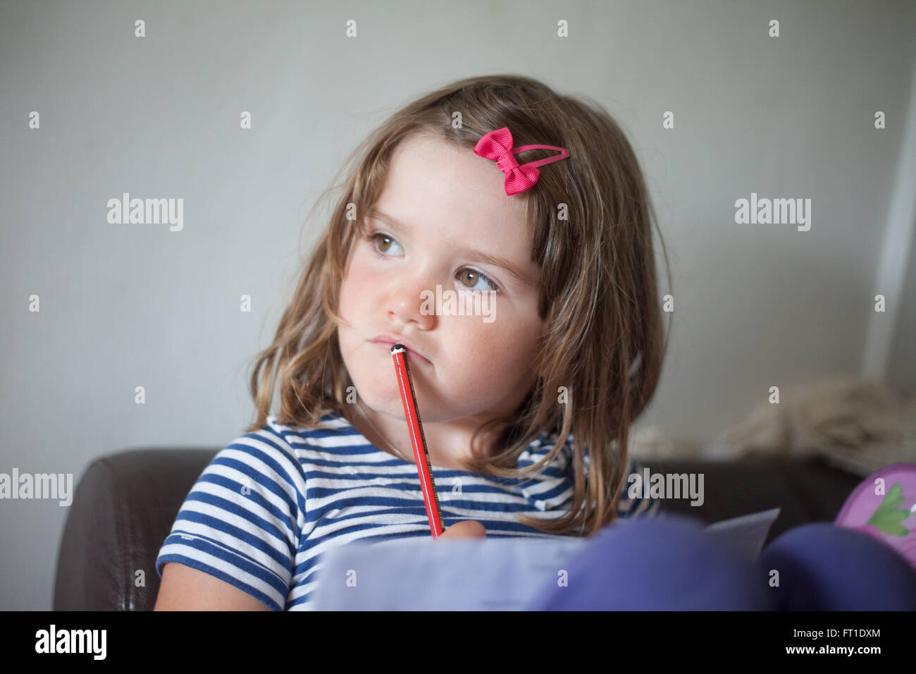 Girl child thinking what to draw with pencil. Looking for artistic ...