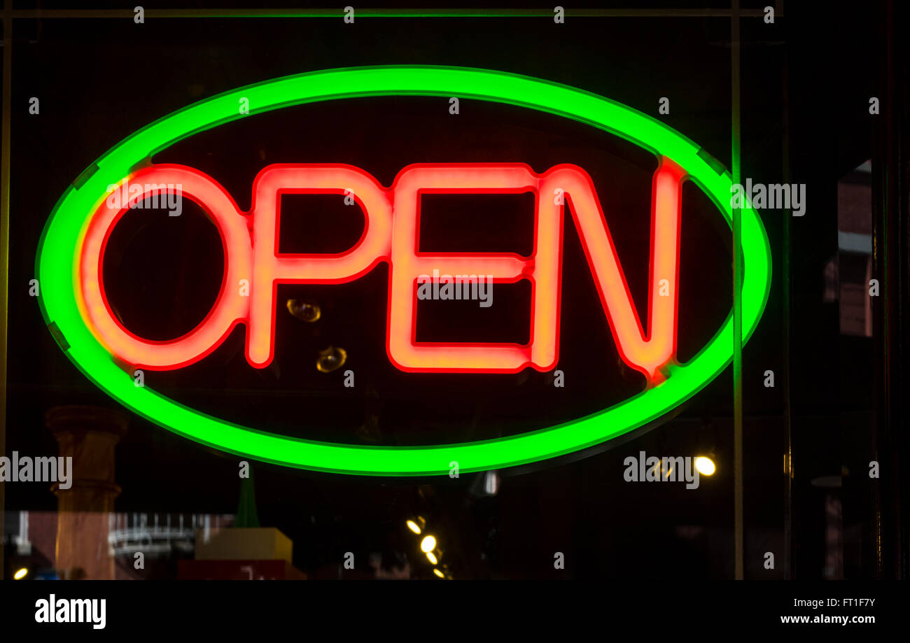 Neon sign saying open in a window Stock Photo - Alamy