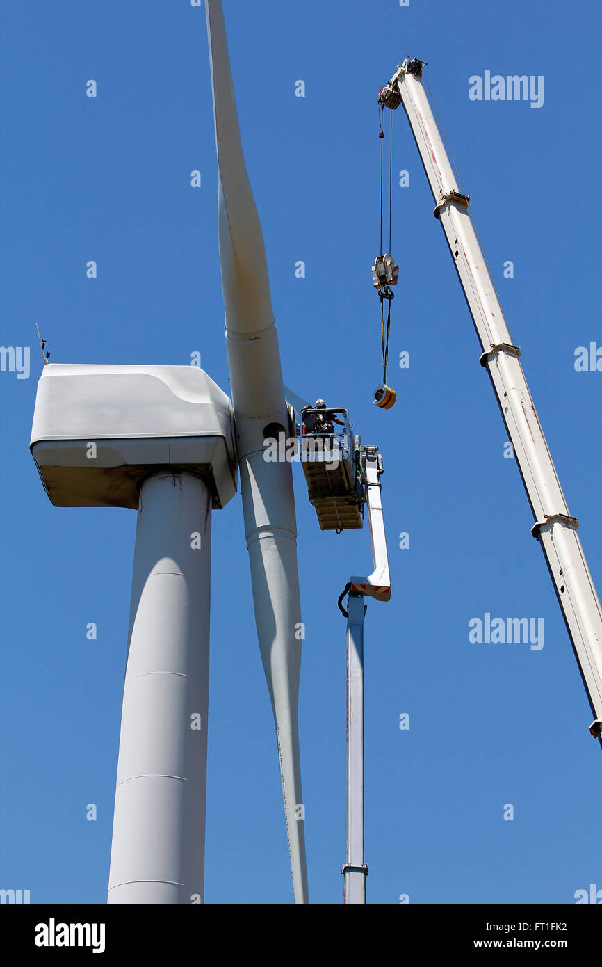 Wind turbine being repaired by two operators Stock Photo - Alamy