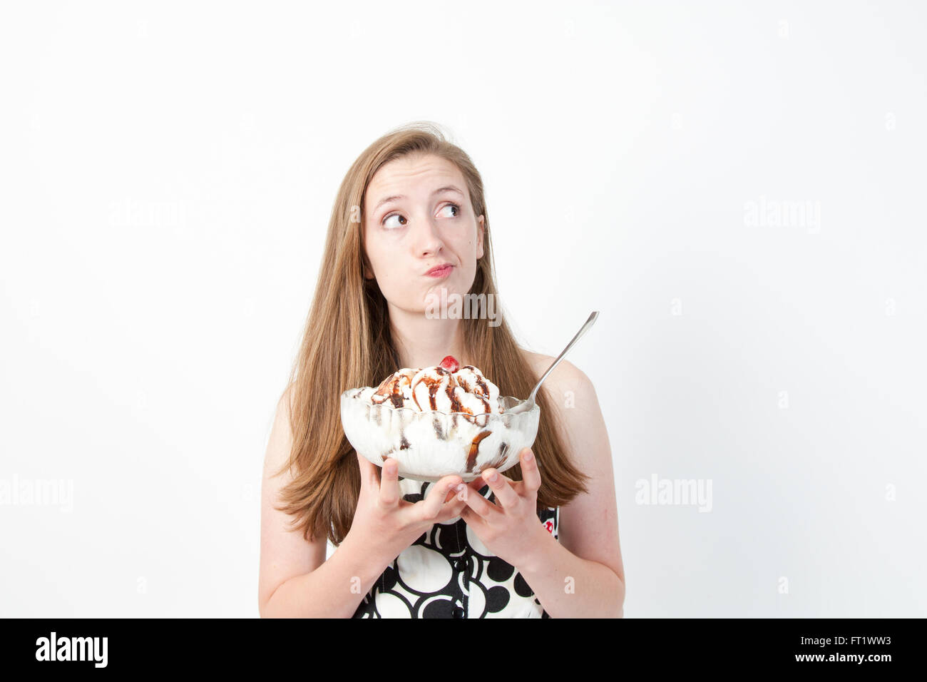 humorous facial expressions of a young woman as she considers the huge ...