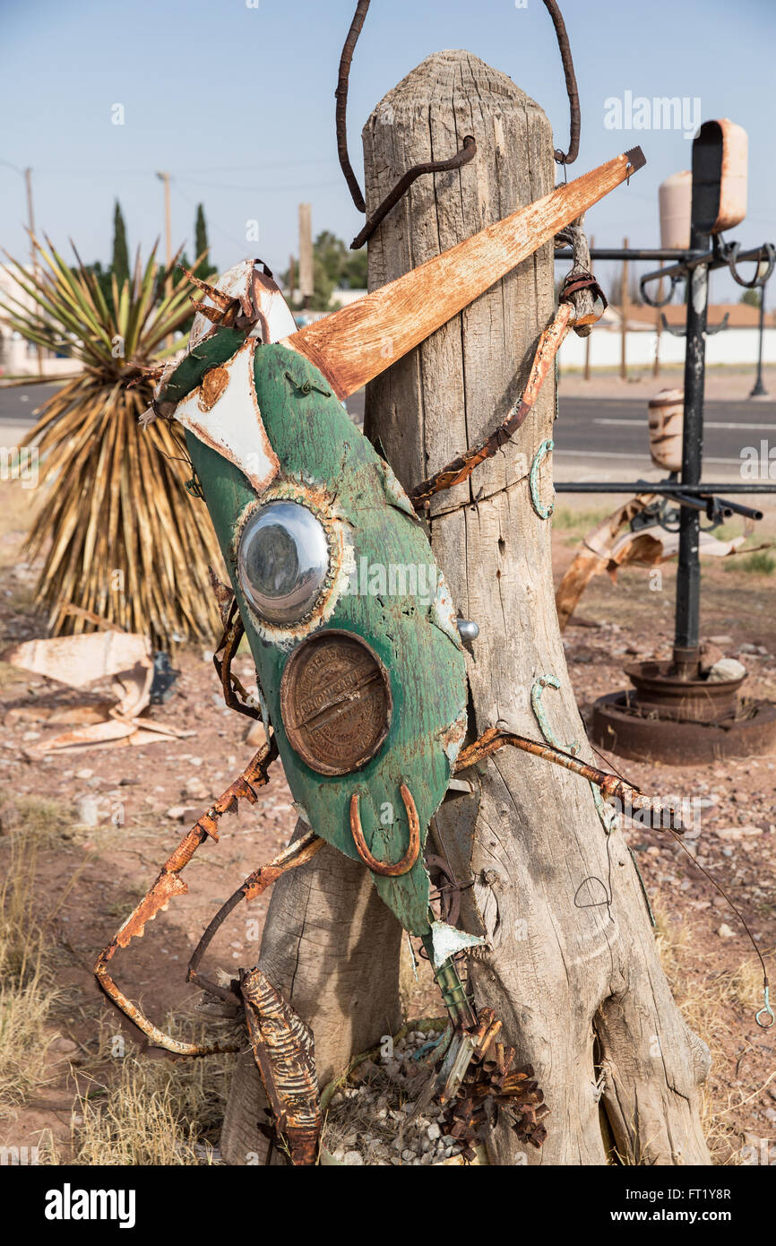 A metal bug statue clings to a log Stock Photo - Alamy