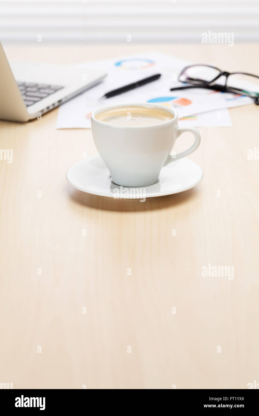 Office workplace with with laptop and coffee on wooden desk table in ...