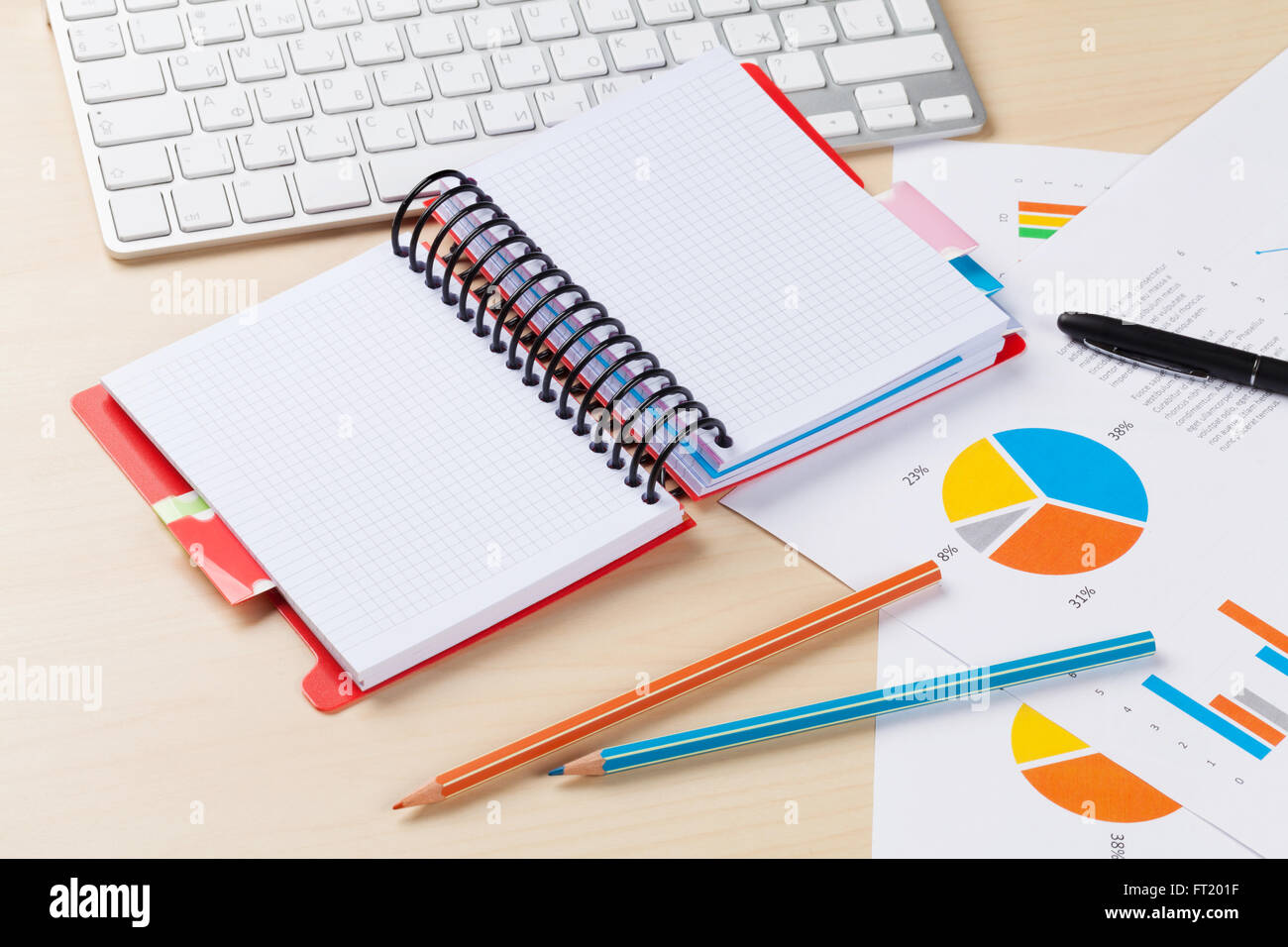 Charts and notepad on wooden table hi-res stock photography and images ...