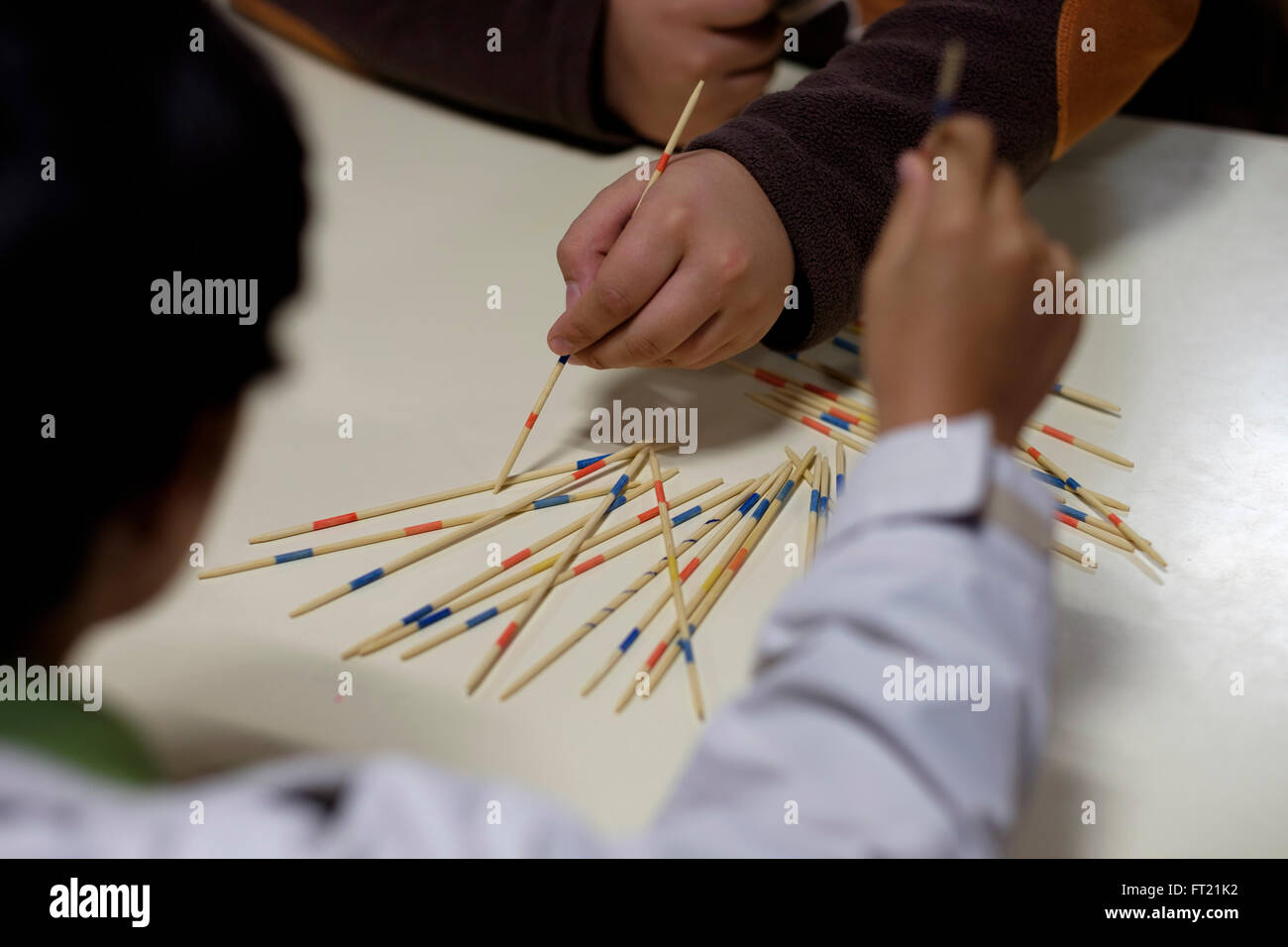 Young children playing Mikado Stock Photo - Alamy