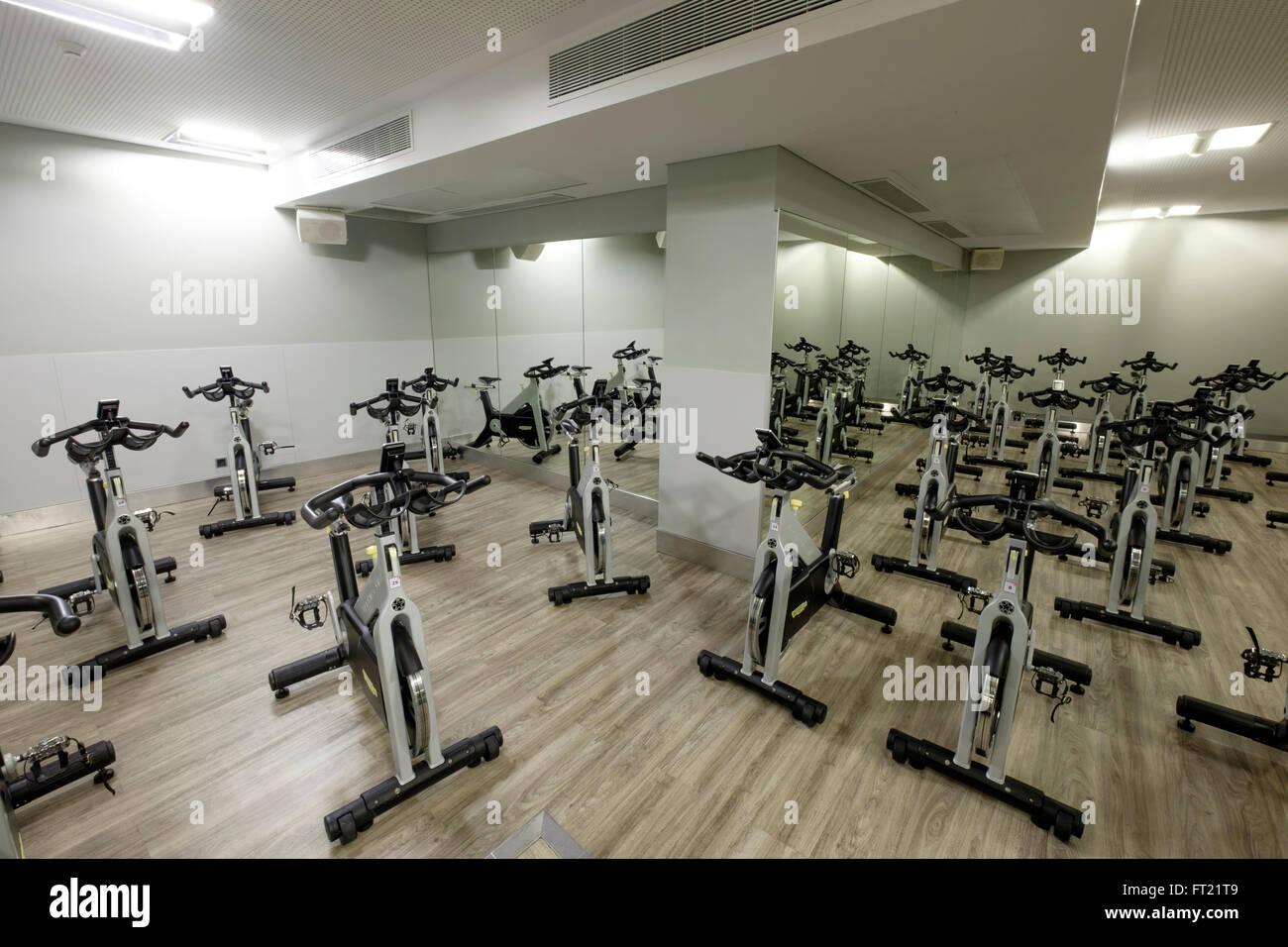 Empty gym exercise room full of stationary bicycles Stock Photo - Alamy
