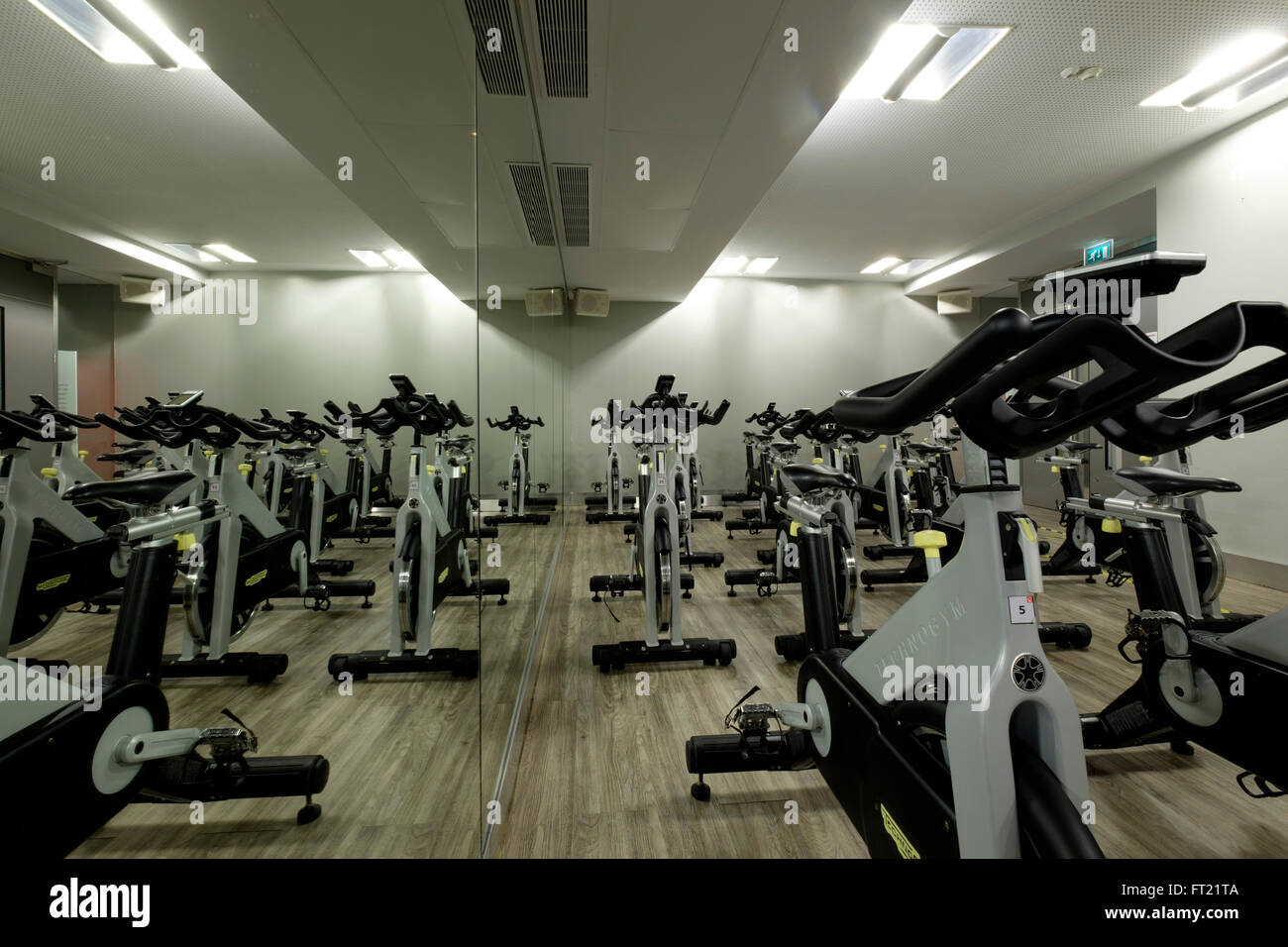 Empty gym exercise room full of stationary bicycles Stock Photo - Alamy
