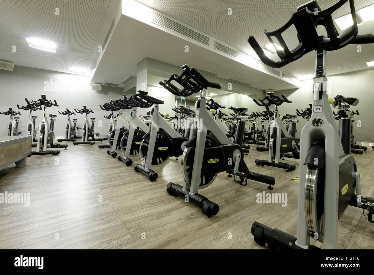 Empty gym exercise room full of stationary bicycles Stock Photo - Alamy