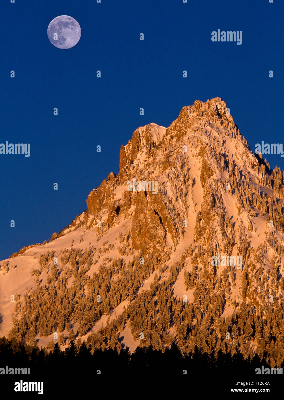moon over ross peak in winter in the bridger range near bozeman ...