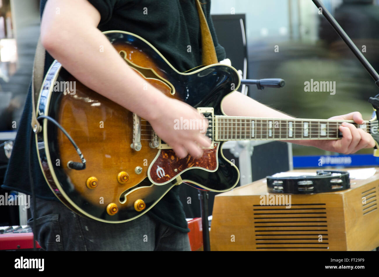 A closeup of a guitarist playing an electric guitar Stock Photo - Alamy