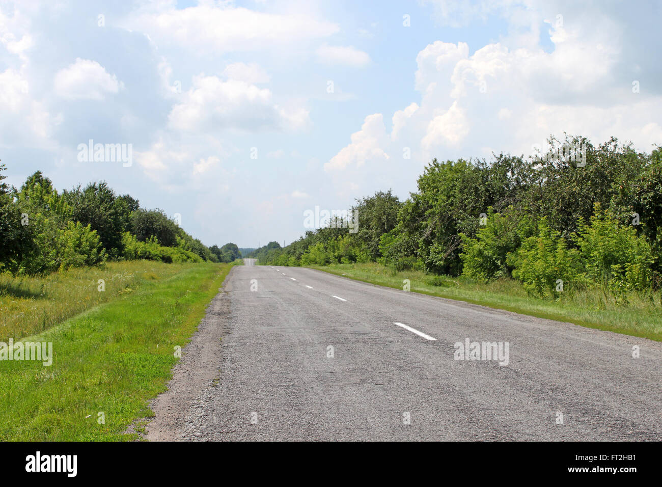 Long country road with white lines in the center Stock Photo - Alamy