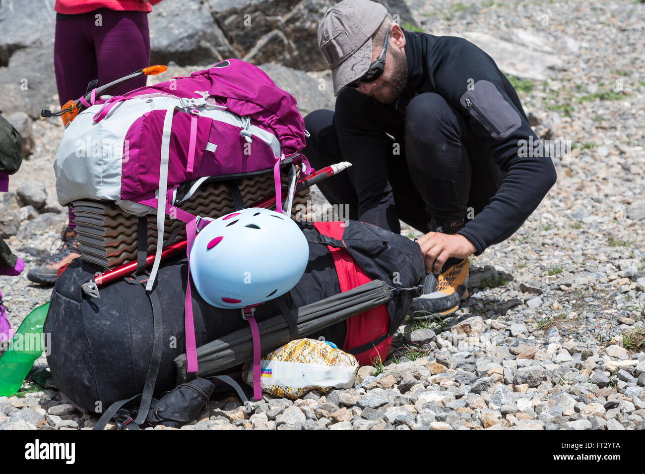 Hiker Packing Backpack Stock Photo - Alamy