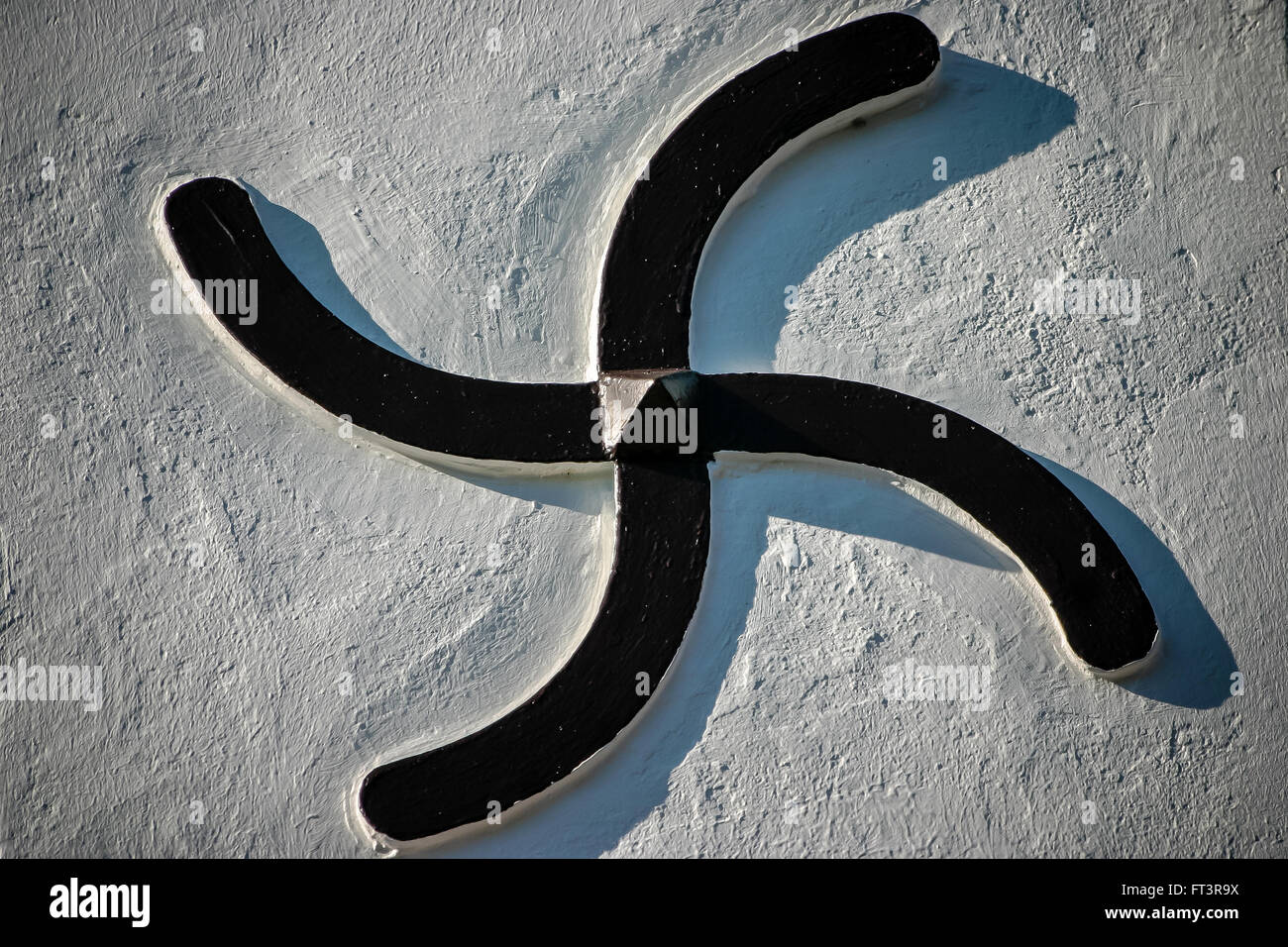 Basque cross on white wall Stock Photo - Alamy