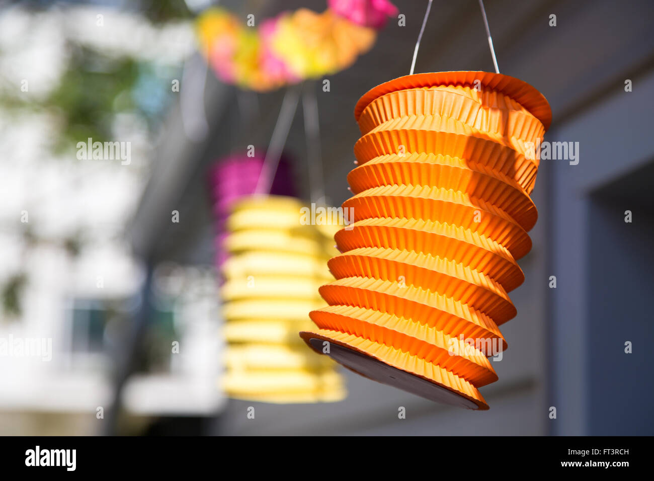 brightly colored paper patio lantern decorations hung from a string in ...