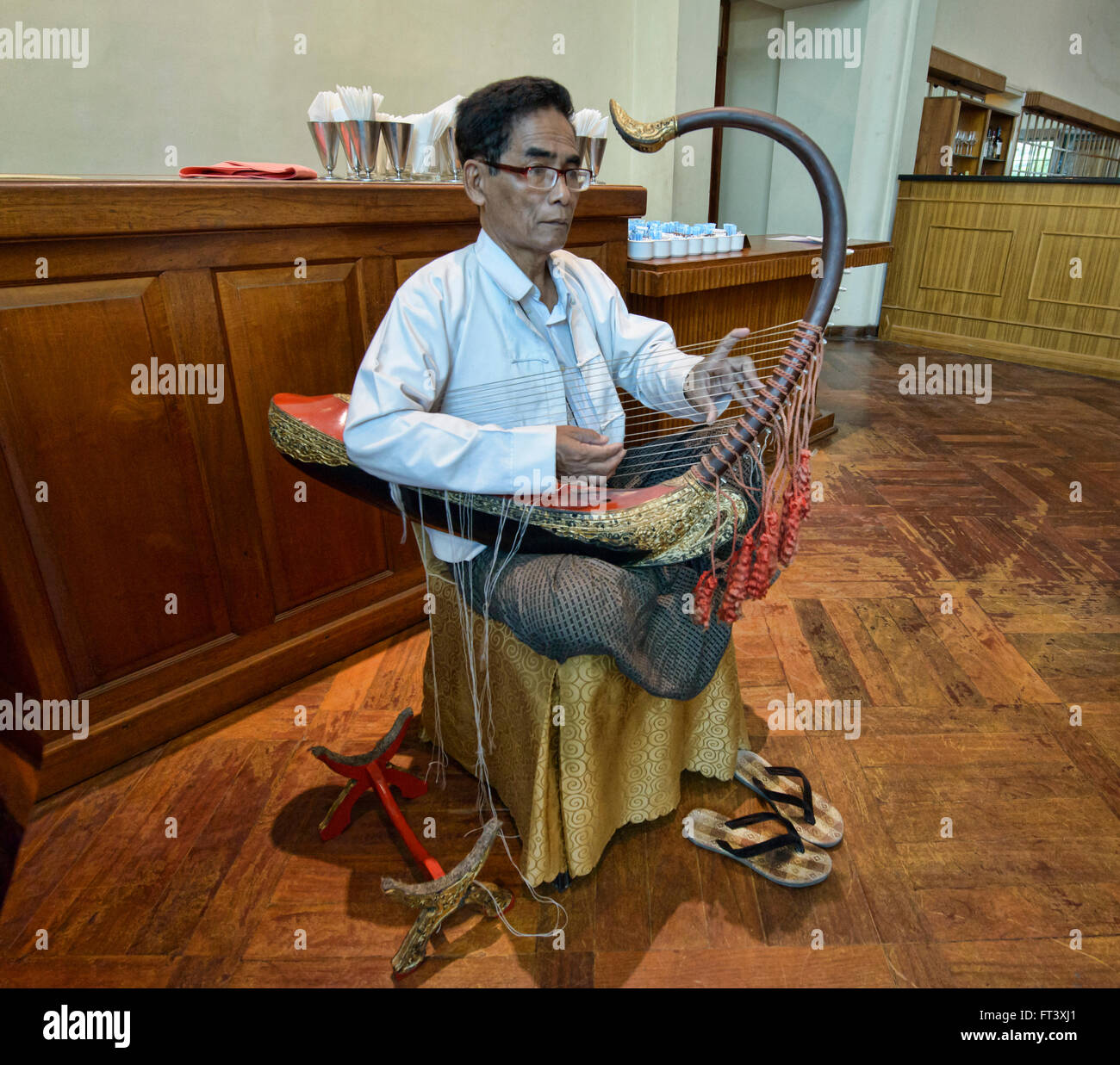 Musician playing a saung, traditional Burmese arched harp, Yangon ...