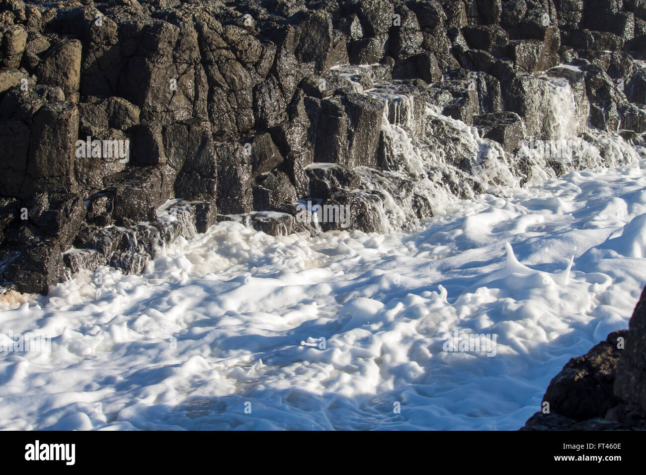 Splashing, foaming white backwash from the Indian Ocean waves breaking ...