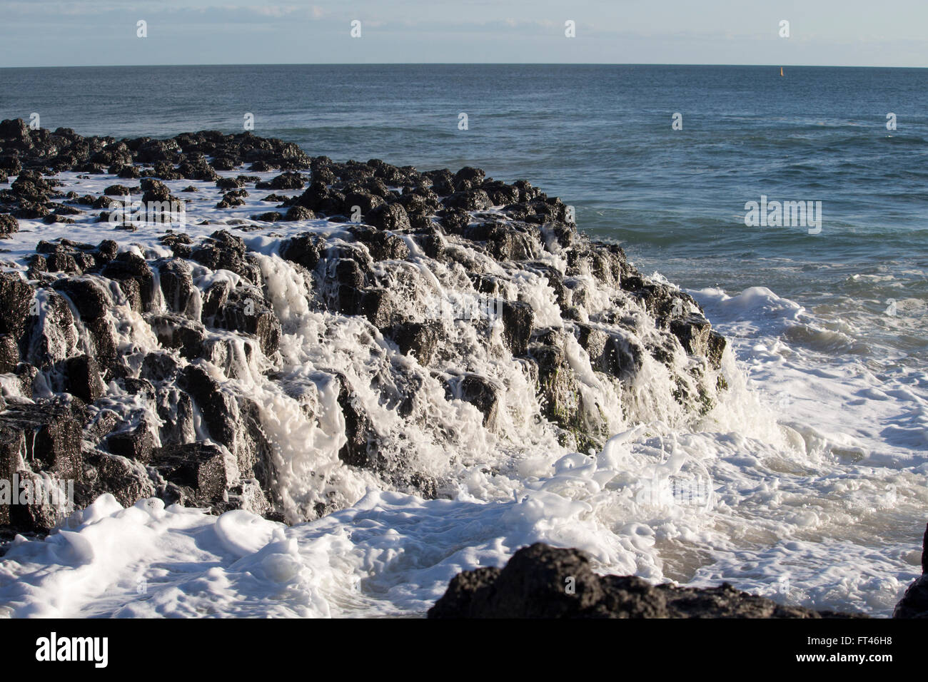 Splashing, foaming white backwash from the Indian Ocean waves breaking ...