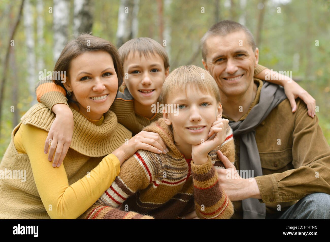 Family in autumn park Stock Photo - Alamy