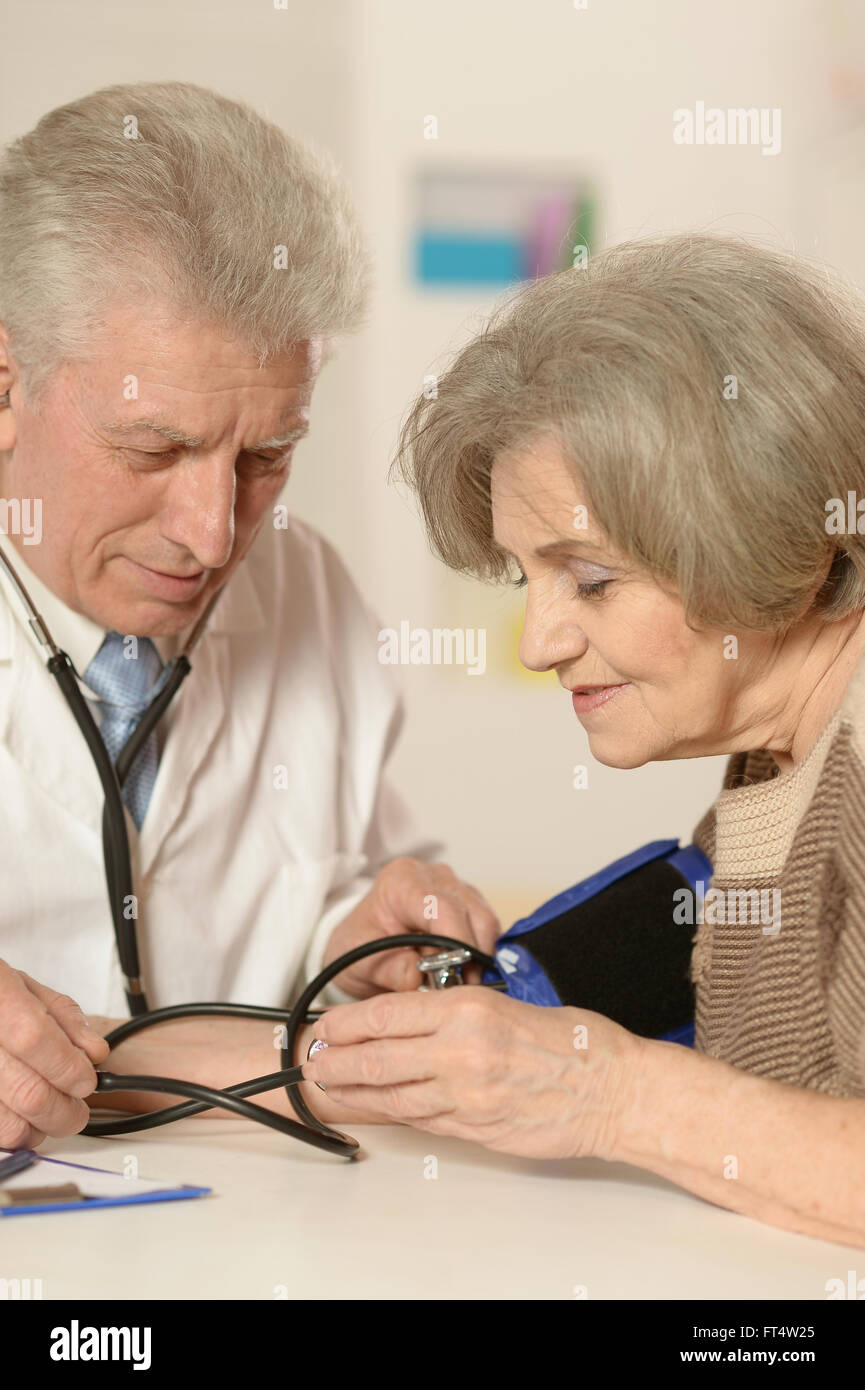 Elderly doctor with patient Stock Photo - Alamy