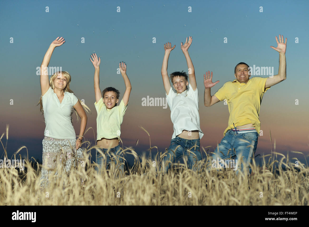 Smiling family jumping Stock Photo - Alamy