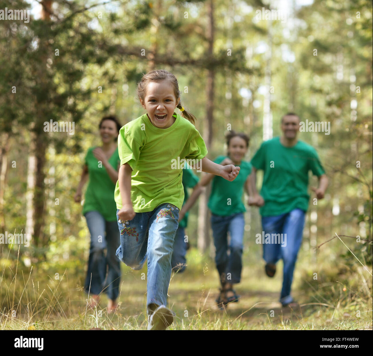 Friendly family running Stock Photo - Alamy