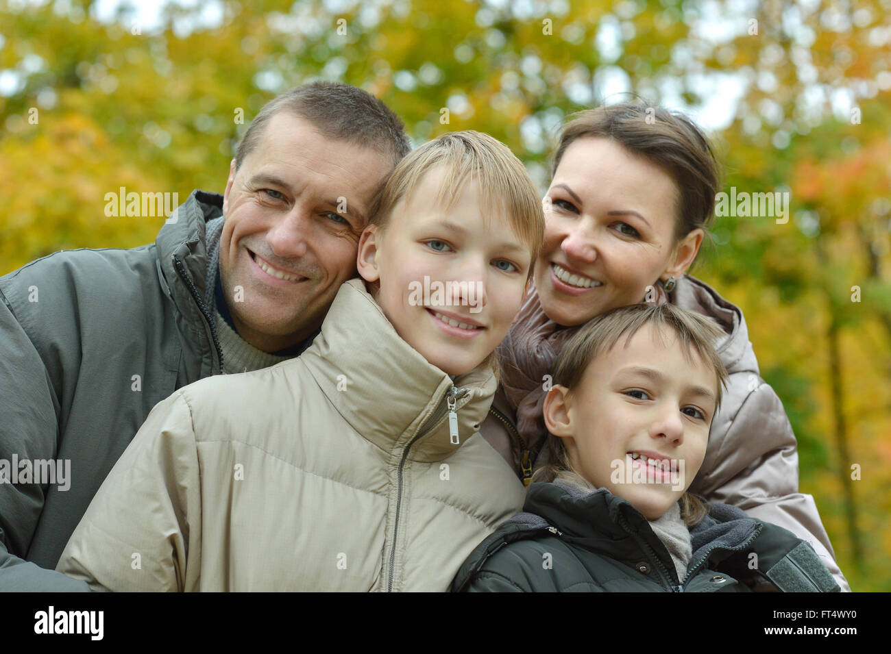 Family in autumn park Stock Photo - Alamy