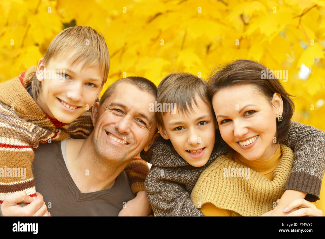 Family in autumn park Stock Photo - Alamy