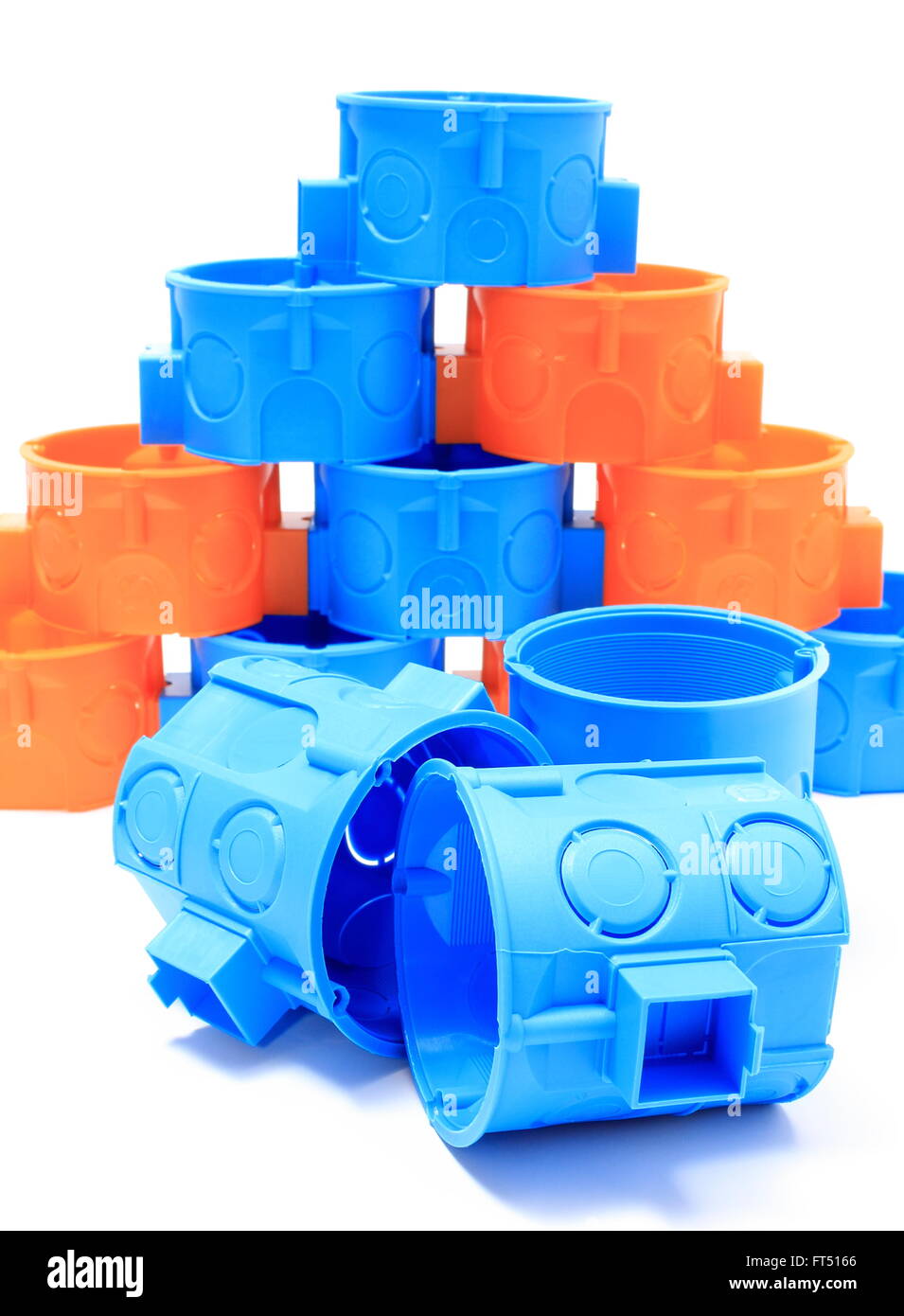 Blue and orange plastic electrical boxes on white background ...
