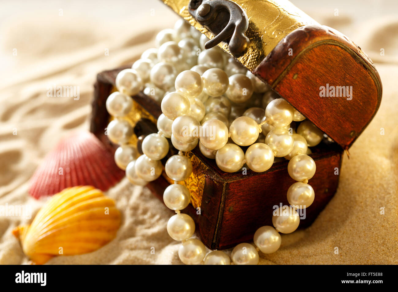 Treasure chest with seashells and pearl on sand Stock Photo - Alamy