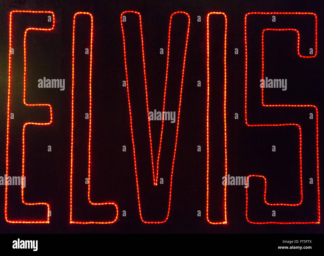 A photograph of a neon signing saying 'ELVIS'. The photograph was taken ...