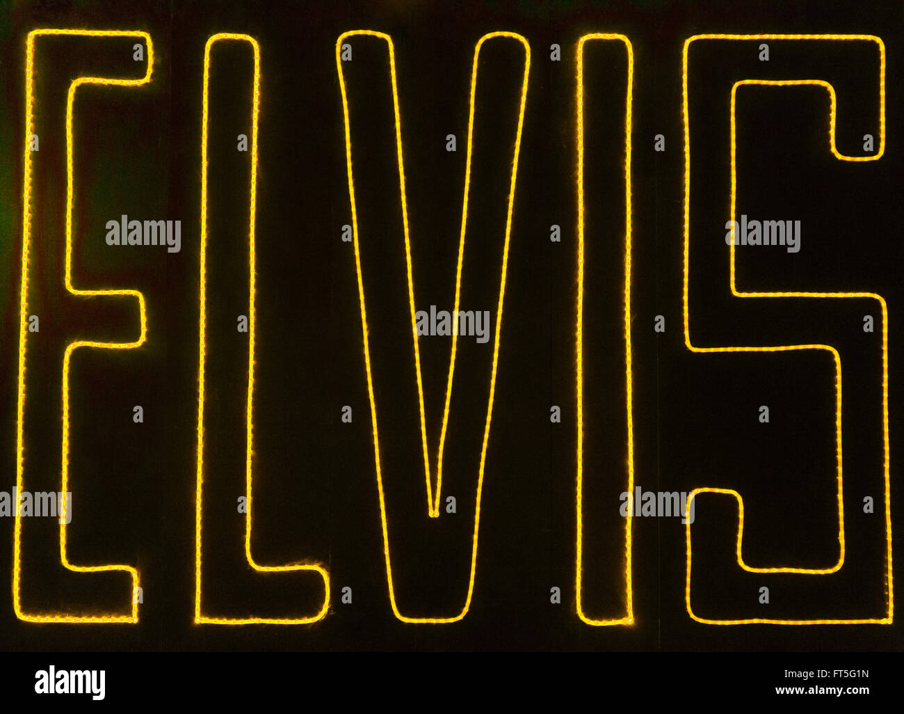 A photograph of a neon signing saying 'ELVIS'. The photograph was taken ...
