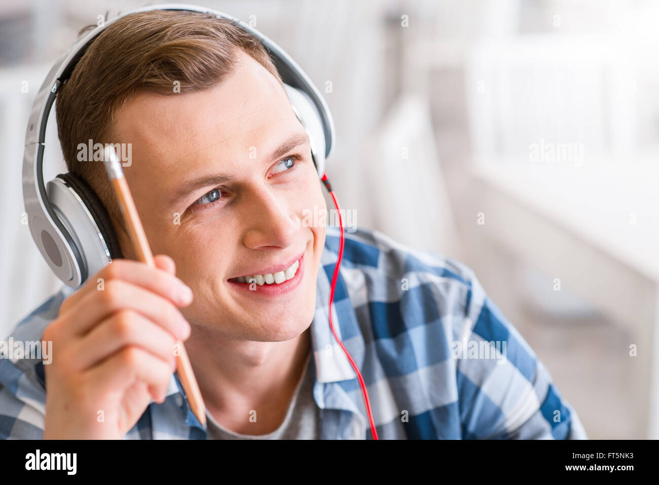 Cheerful guy listening to music Stock Photo - Alamy