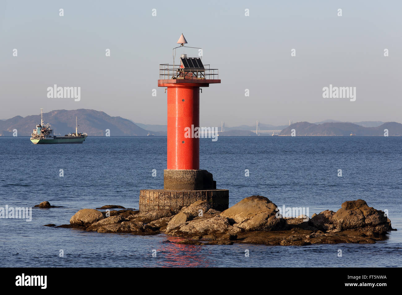 lighthouse with fishing boat in the sea Stock Photo - Alamy