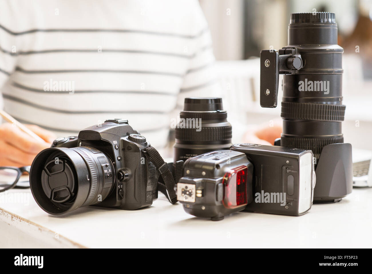 Photo camera lying on the table Stock Photo - Alamy