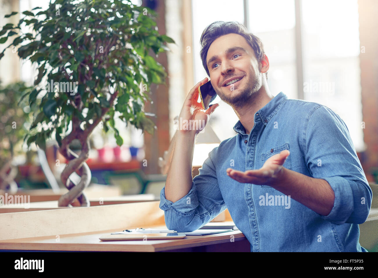Content man talking on mobile phone Stock Photo - Alamy