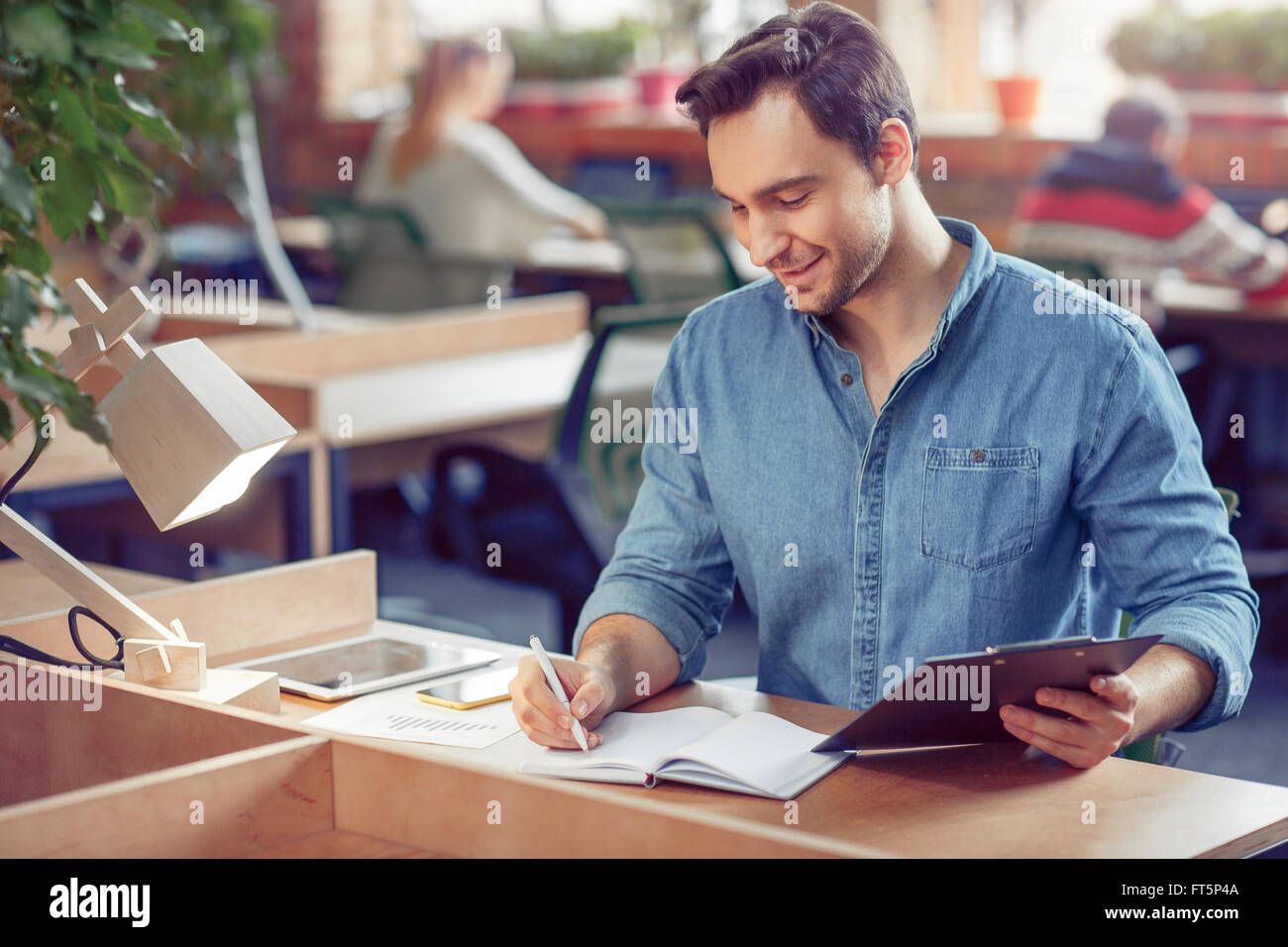 Handsome man sitting at the table Stock Photo - Alamy