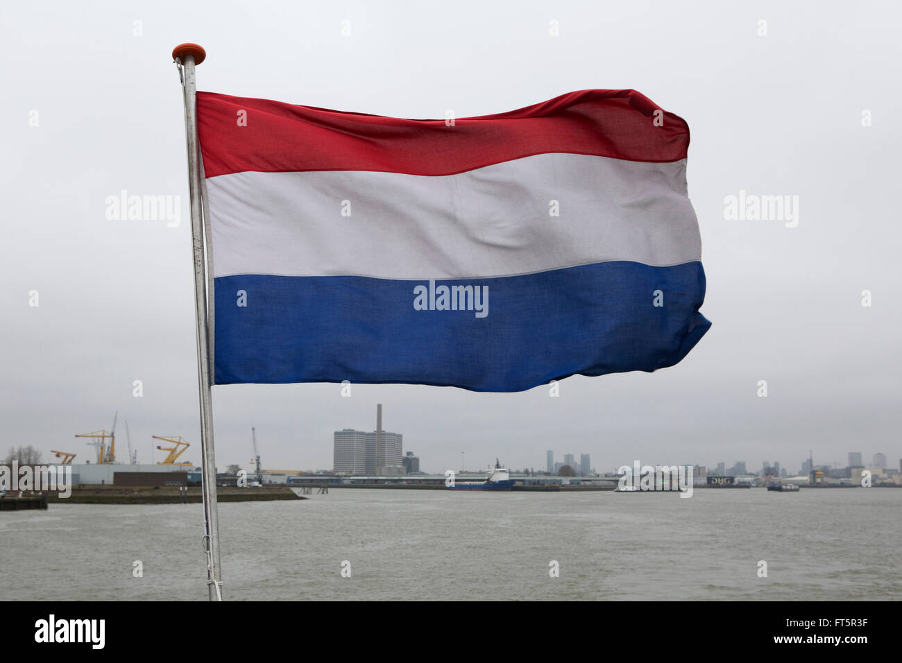 A Dutch flag flies on a ship on the River Meuse in Rotterdam, the ...